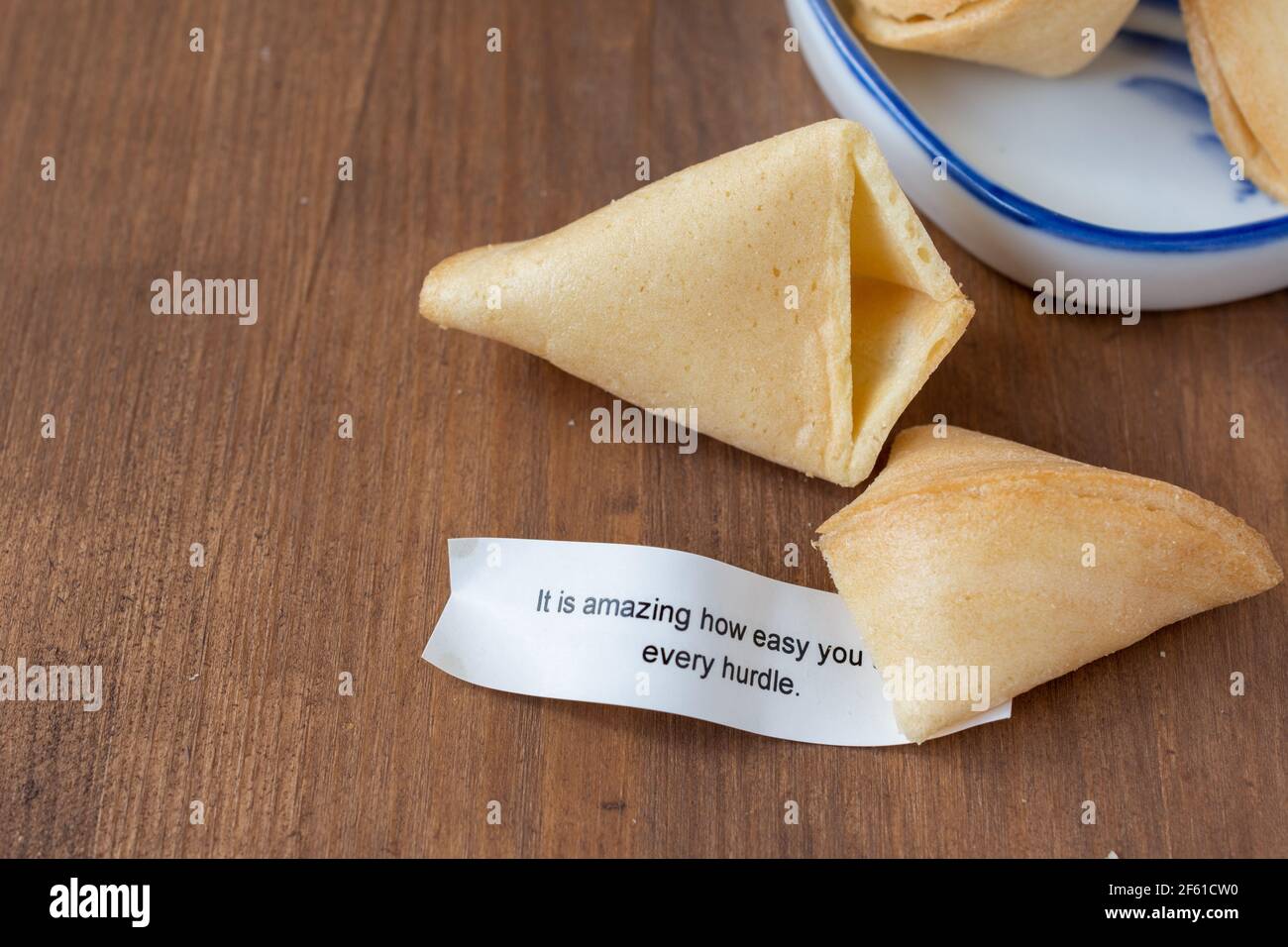 Top view of open fortune cookie with message, on wooden table ...