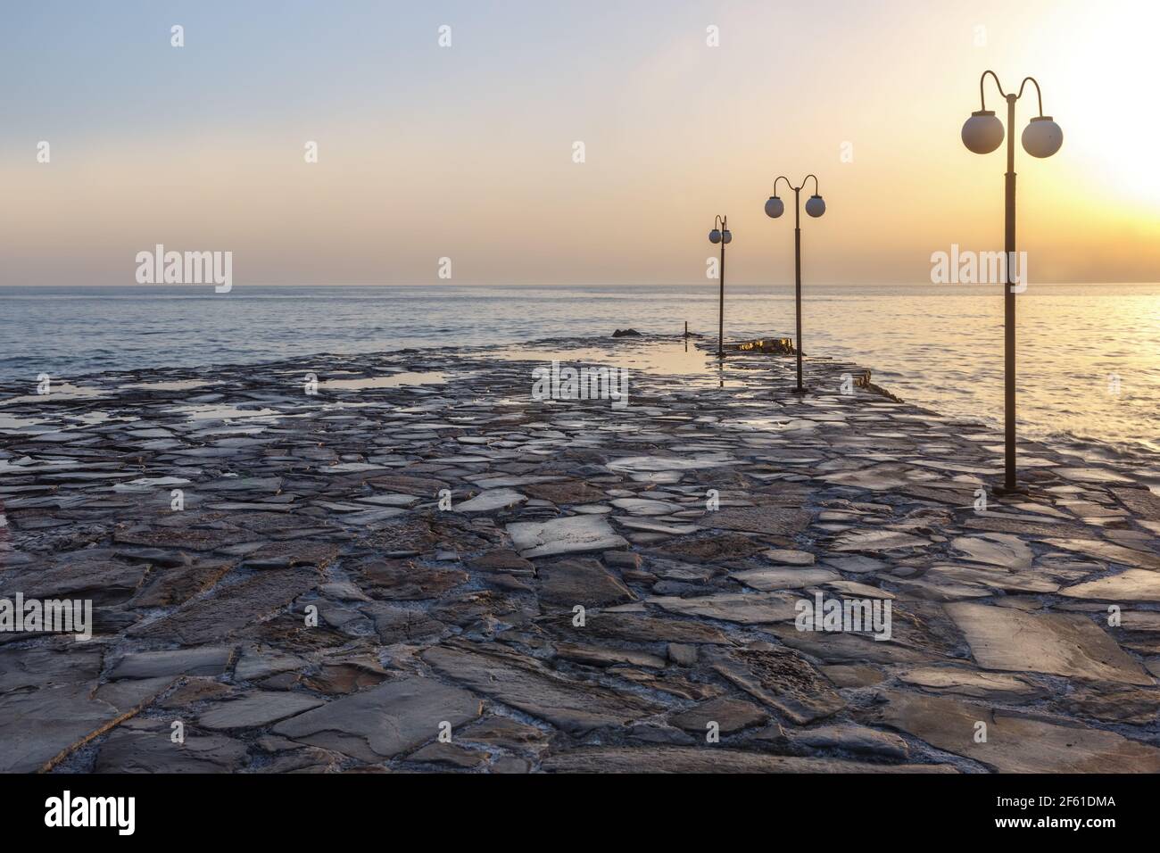 Stone pier lanterns filled with sea water at dawn Stock Photo - Alamy