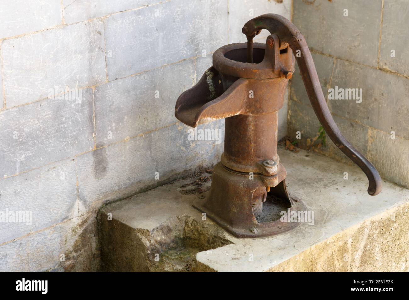 Ancient rusty pump for water flow on the street Stock Photo - Alamy