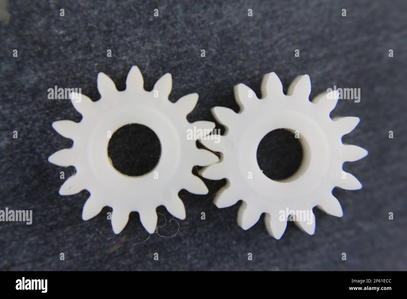 Gear, isolated of white plastic, on slate stone Stock Photo - Alamy
