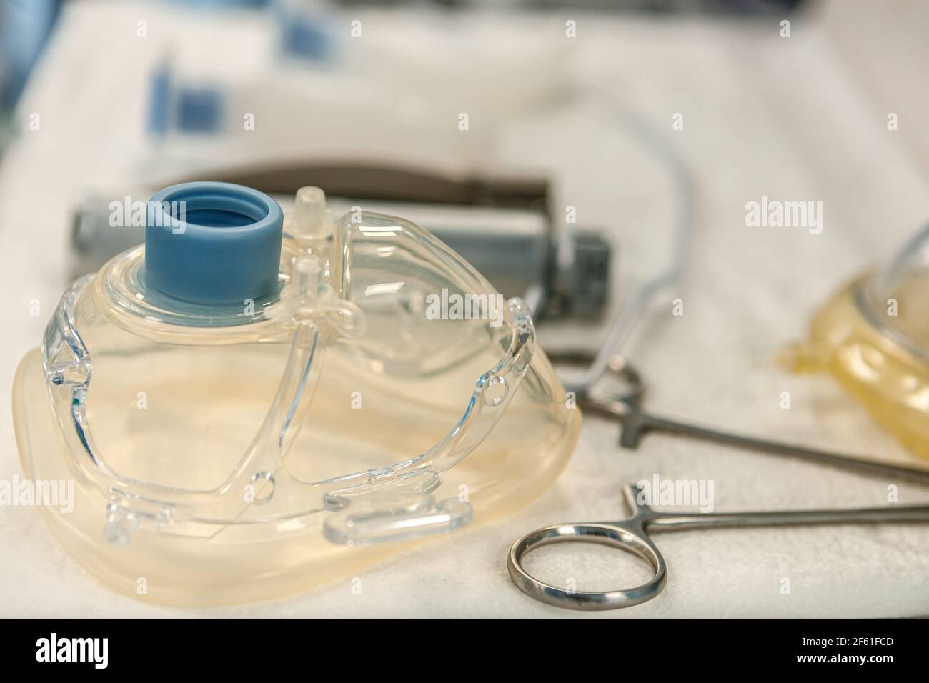 A medical oxygen mask is lying on the table in the operating room. The ...
