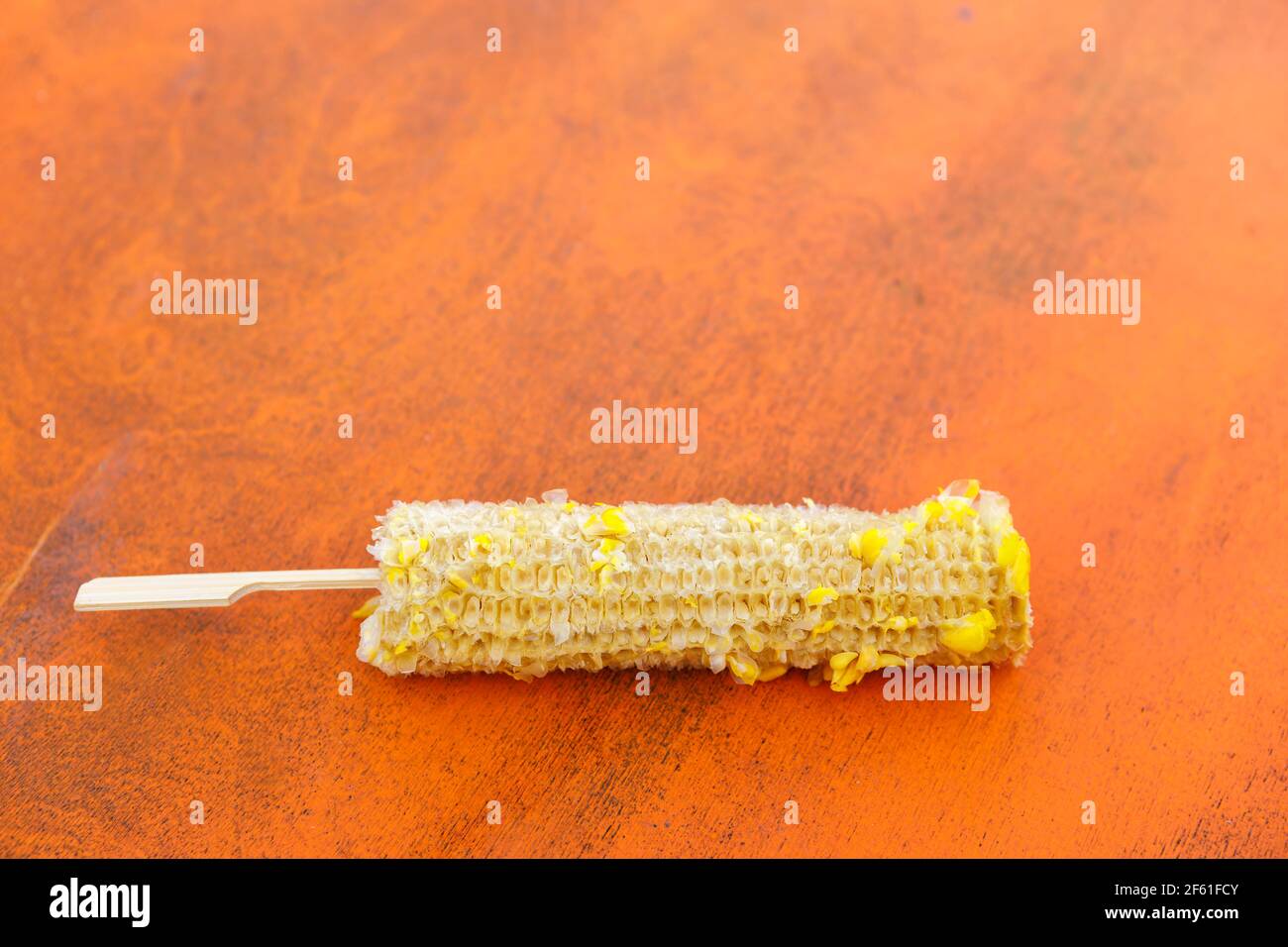 A gnawed cob of freshly boiled corn on the table. Fast food concept ...