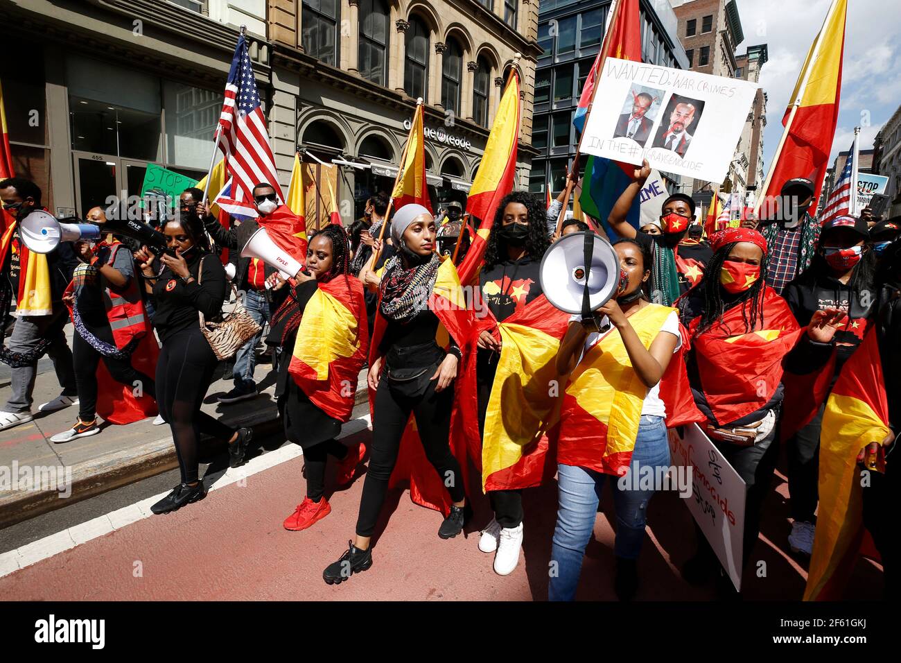Demonstrators march in the streets draped in Tigray flags and chanting ...
