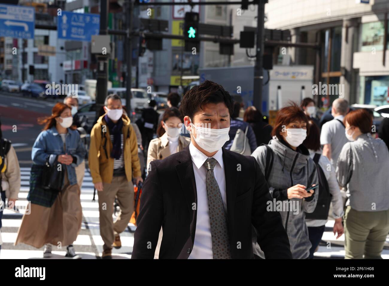 Pedestrians wearing face masks as a preventive measure against Covid-19 ...