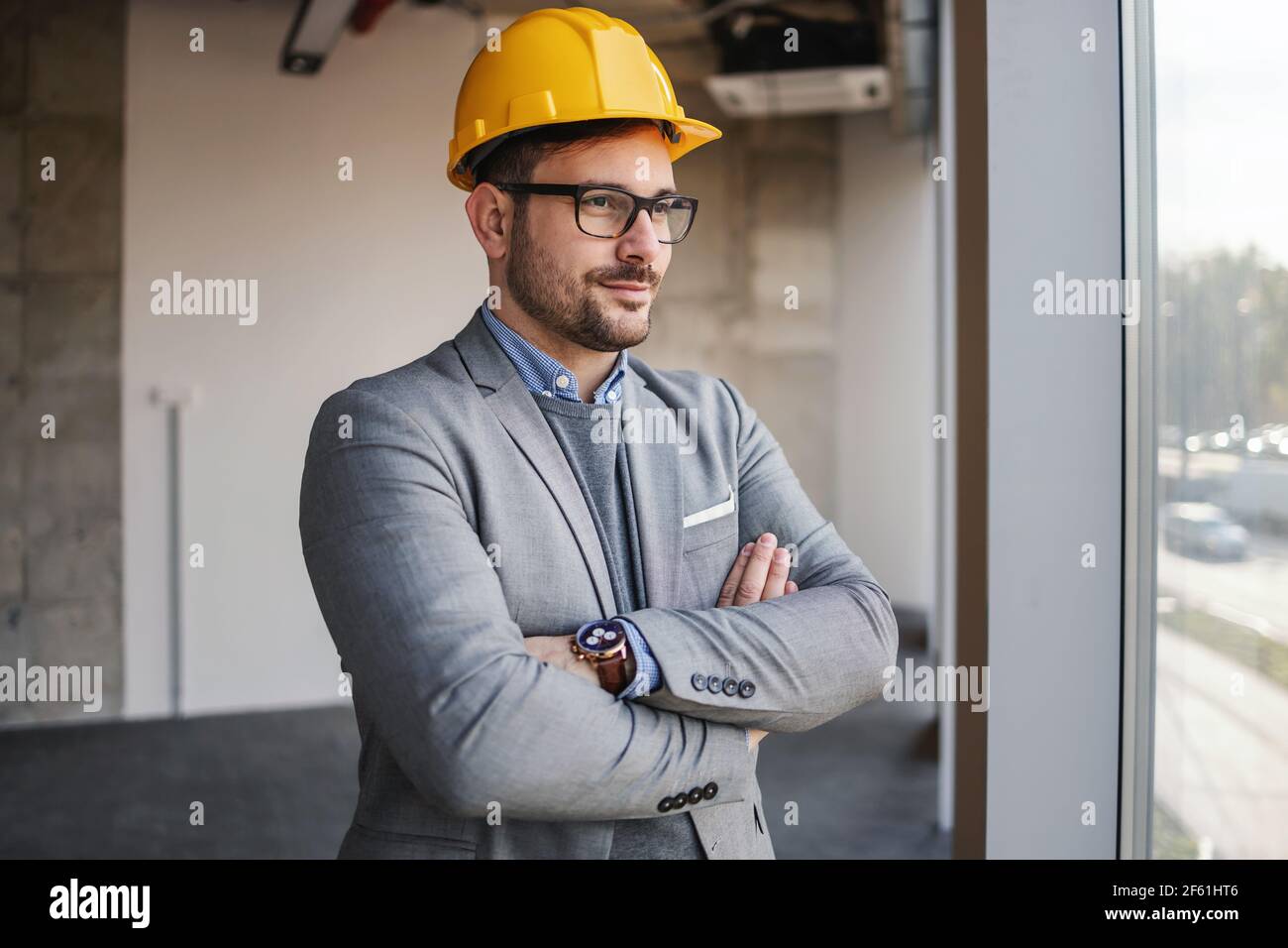 Successful architect standing in building in construction process with ...