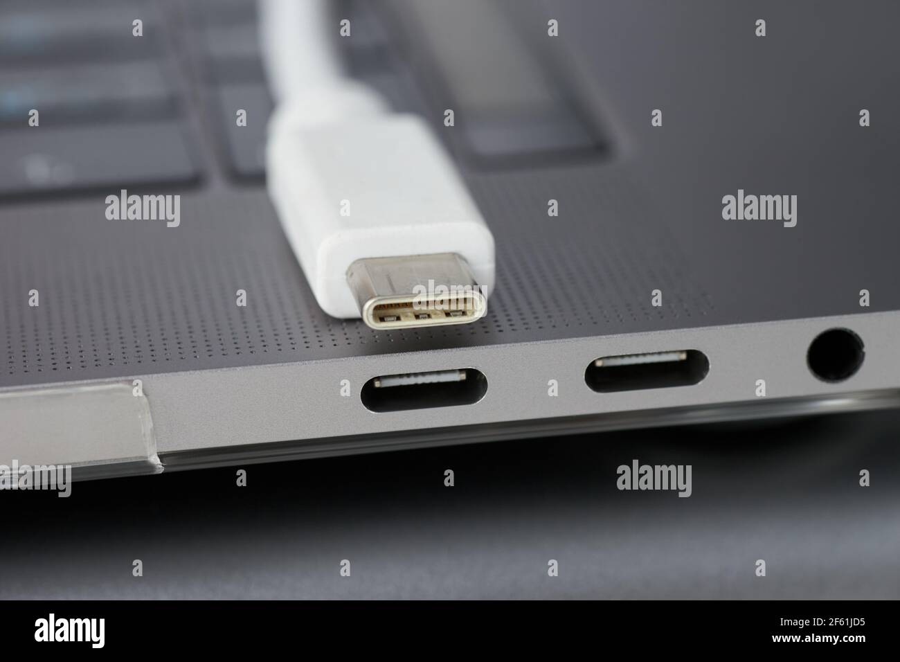 Close-up photo of laptop type-c ports, type-c cable and 3.5 jack. No ...