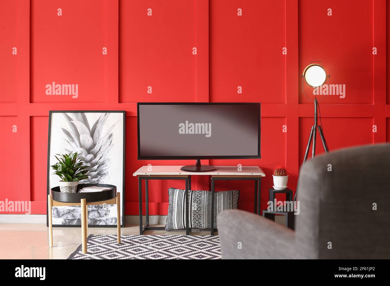 Interior of living room with modern TV near color wall Stock Photo - Alamy