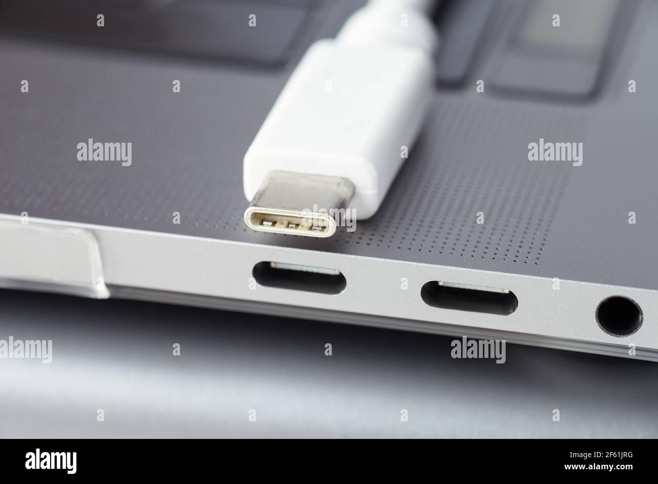 Close-up photo of laptop type-c ports, type-c cable and 3.5 jack. No ...