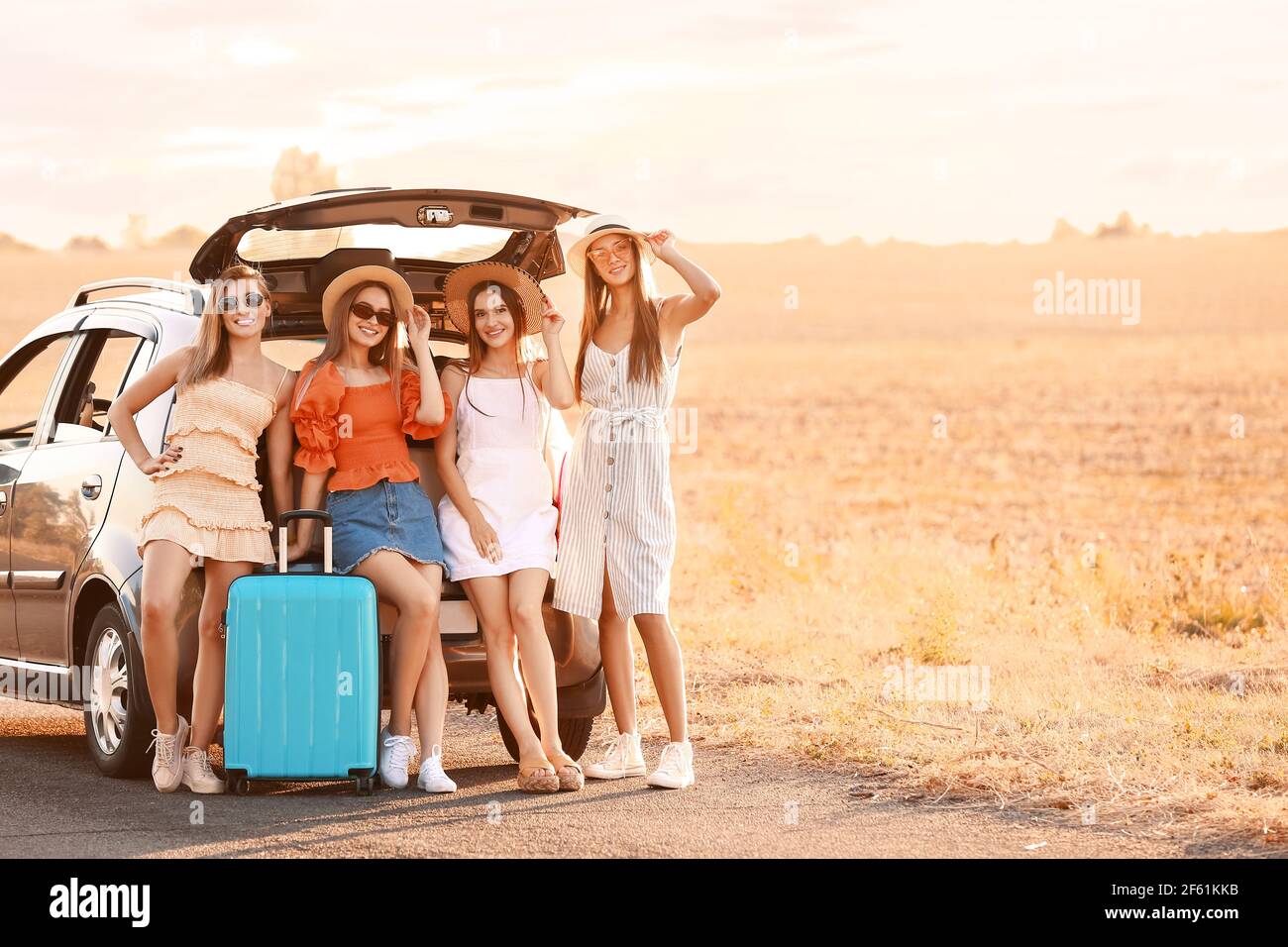 Happy young women near modern car Stock Photo - Alamy