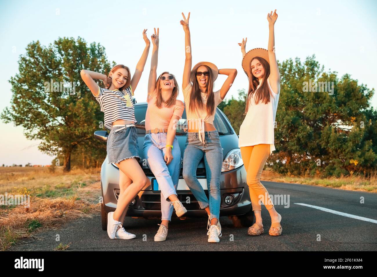 Happy young women near modern car Stock Photo - Alamy
