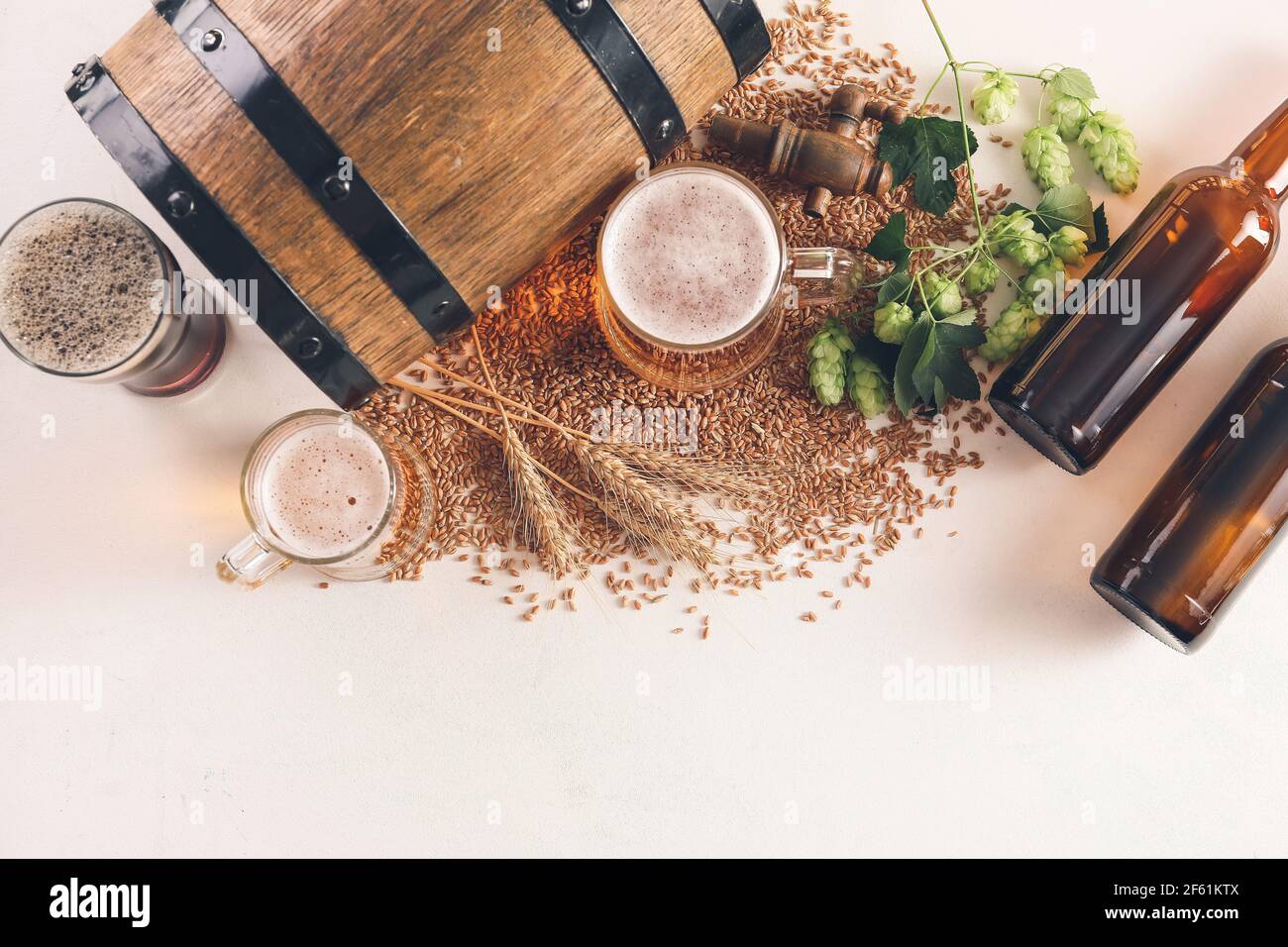 Composition with fresh beer on light background Stock Photo - Alamy