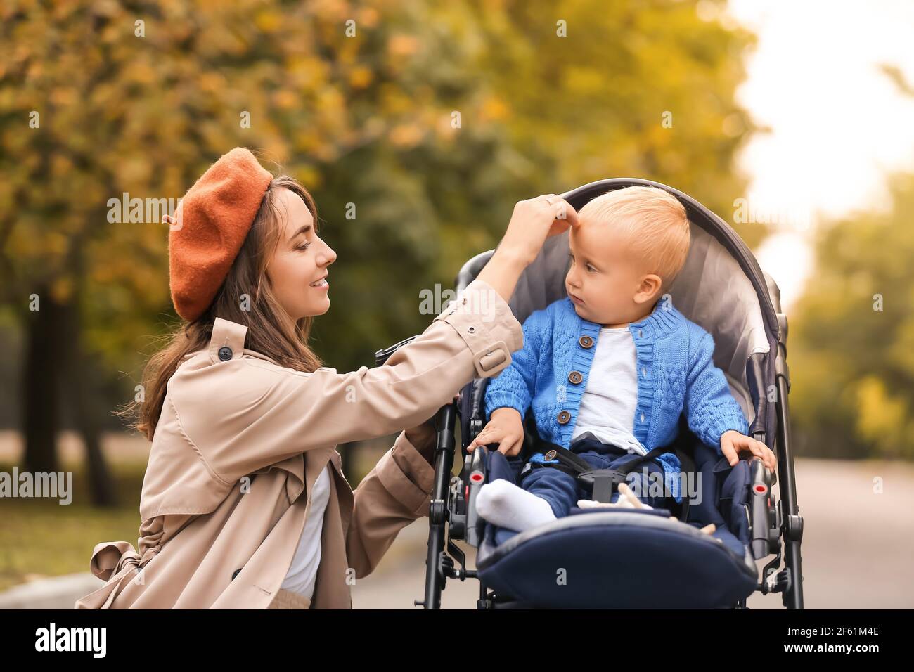 Woman and her cute baby in stroller outdoors Stock Photo - Alamy