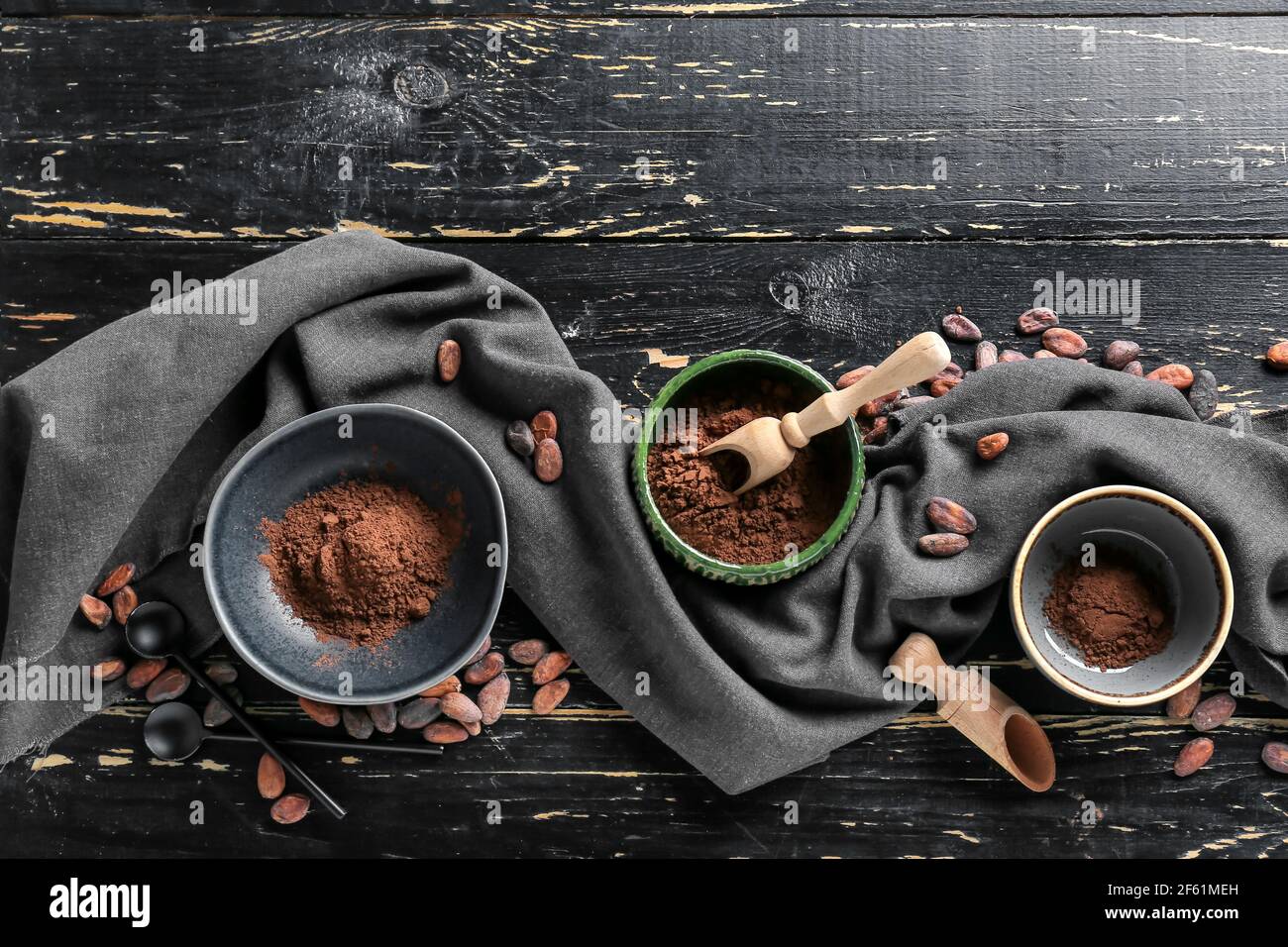 Bowls with cacao powder and beans on dark wooden background Stock Photo ...
