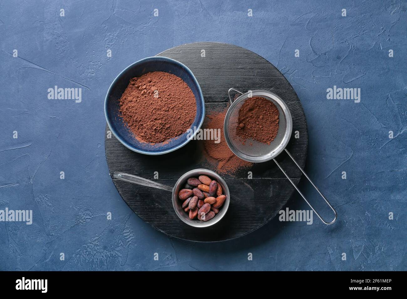 Bowls with cacao powder and beans on dark background Stock Photo - Alamy
