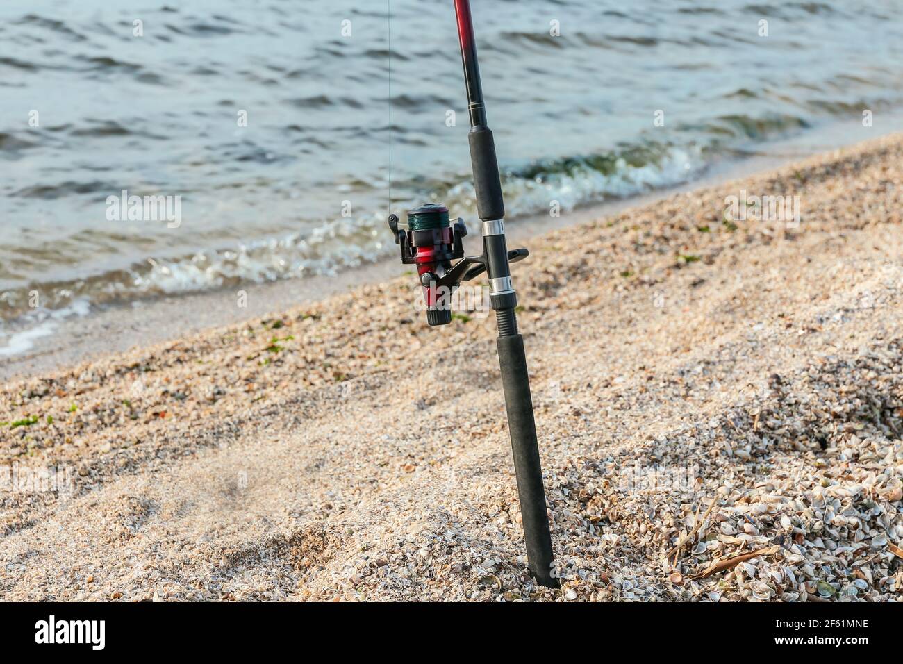 Fishing rod on river bank Stock Photo - Alamy