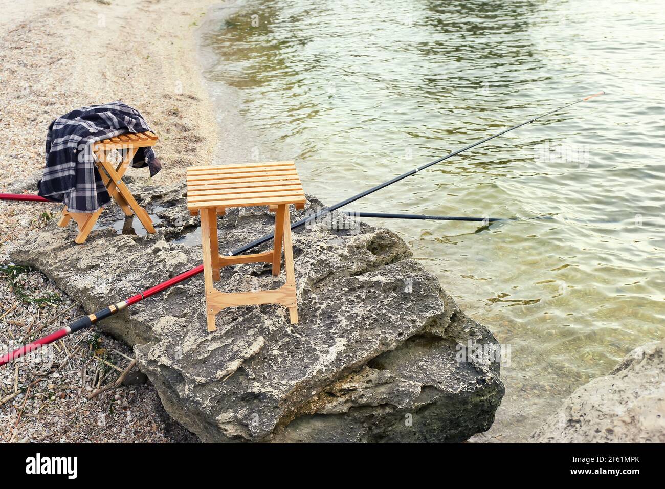 Equipment of fisherman on river bank Stock Photo - Alamy