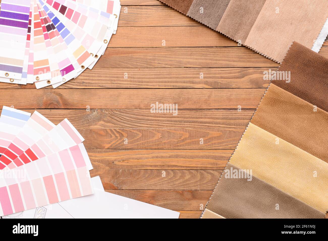 Frame made of color palettes and fabric samples on wooden background ...