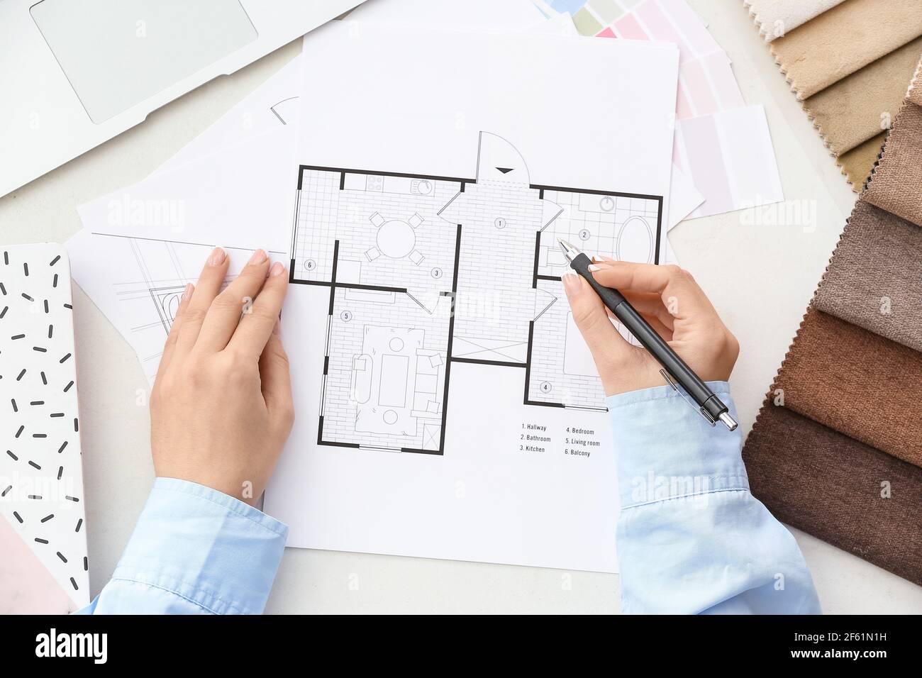 Female interior designer drawing house plan in office Stock Photo - Alamy