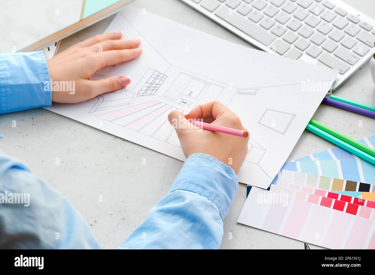 Female interior designer drawing house plan in office Stock Photo - Alamy