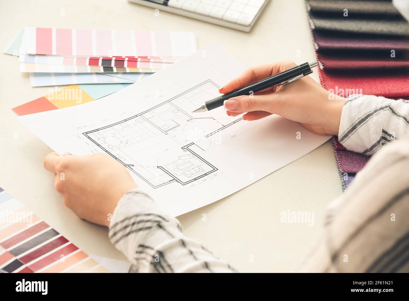Female interior designer with house plan in office Stock Photo - Alamy