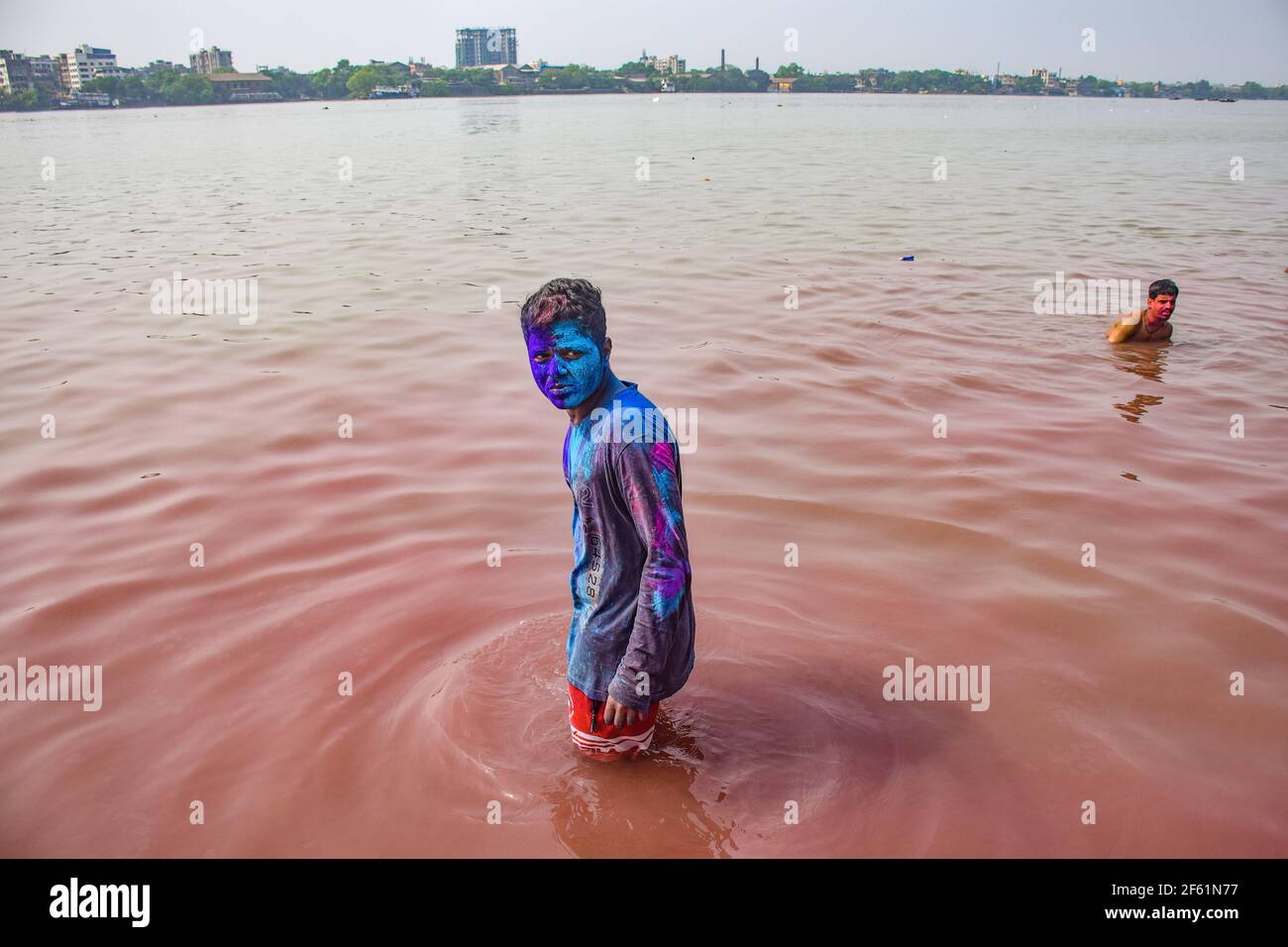 A man's face covered with colourful powders seen during the festival ...