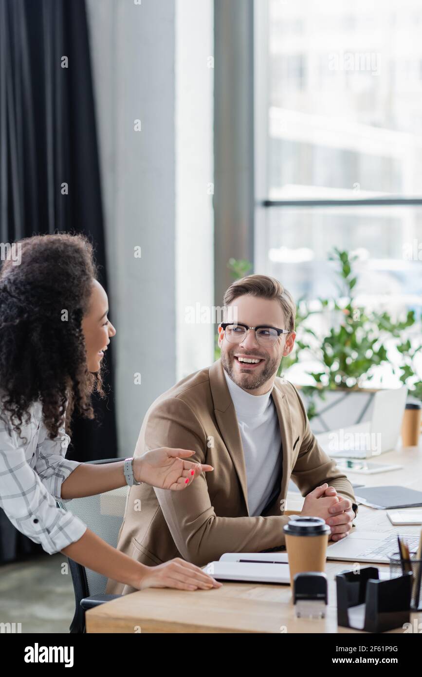 Positive interracial business people working together in office Stock ...