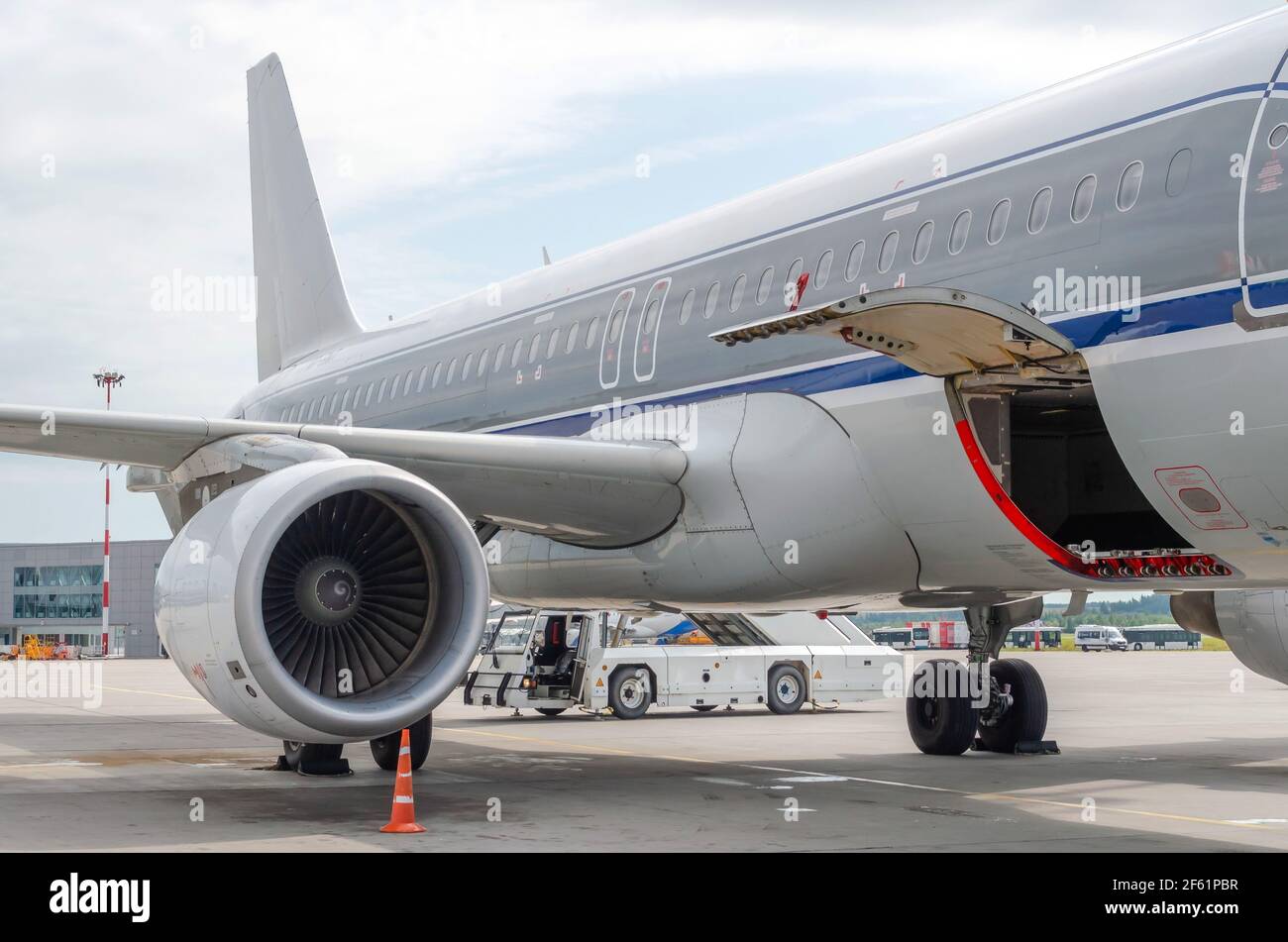 Jet aircraft with open luggage compartment and wing view with engine ...
