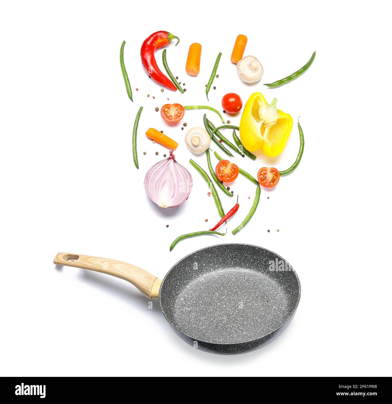 Composition with frying pan and different vegetables on white ...