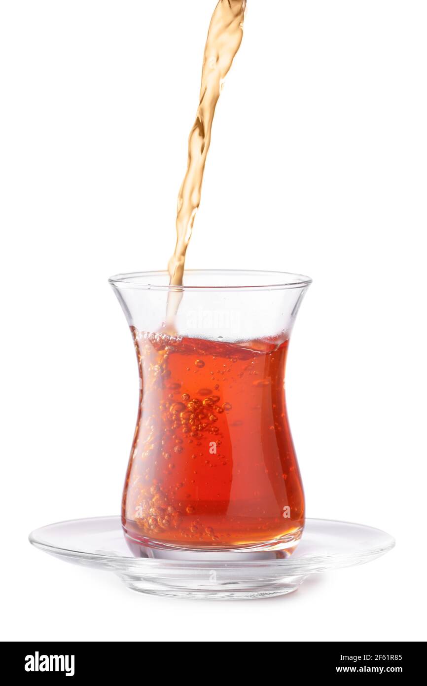 Pouring of hot Turkish tea into glass on white background Stock Photo ...