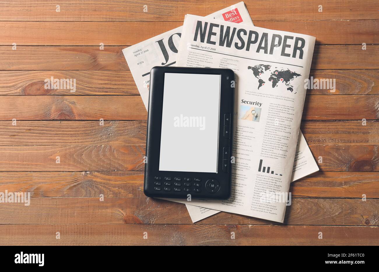 E-reader and newspapers on wooden background Stock Photo - Alamy