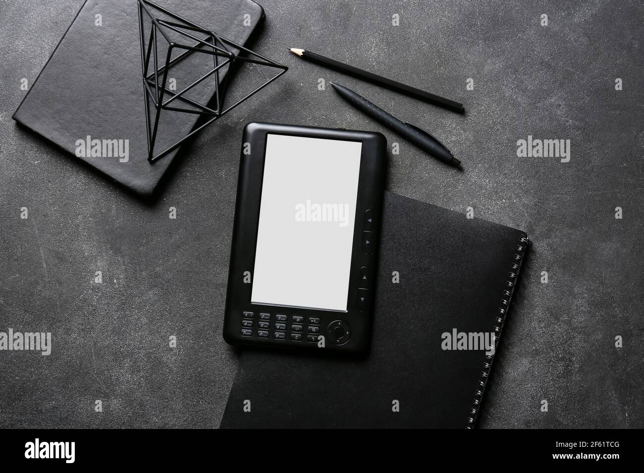 E-reader and notebooks on dark background Stock Photo - Alamy