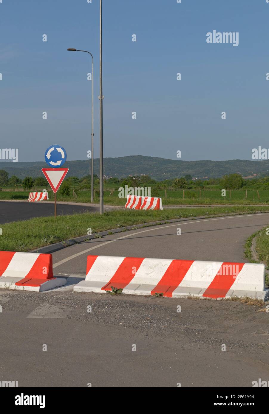 Concrete Barrier Closed Road to Roundabout Intersection Stock Photo - Alamy