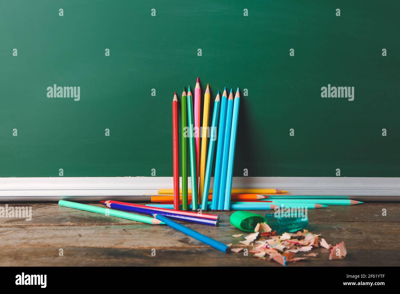 Colorful pencils on table in classroom Stock Photo - Alamy