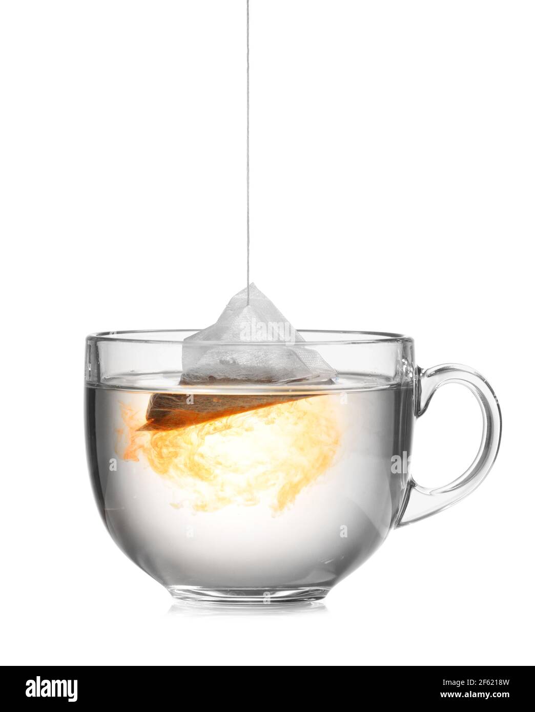Dipping tea bag in hot water on white background Stock Photo - Alamy