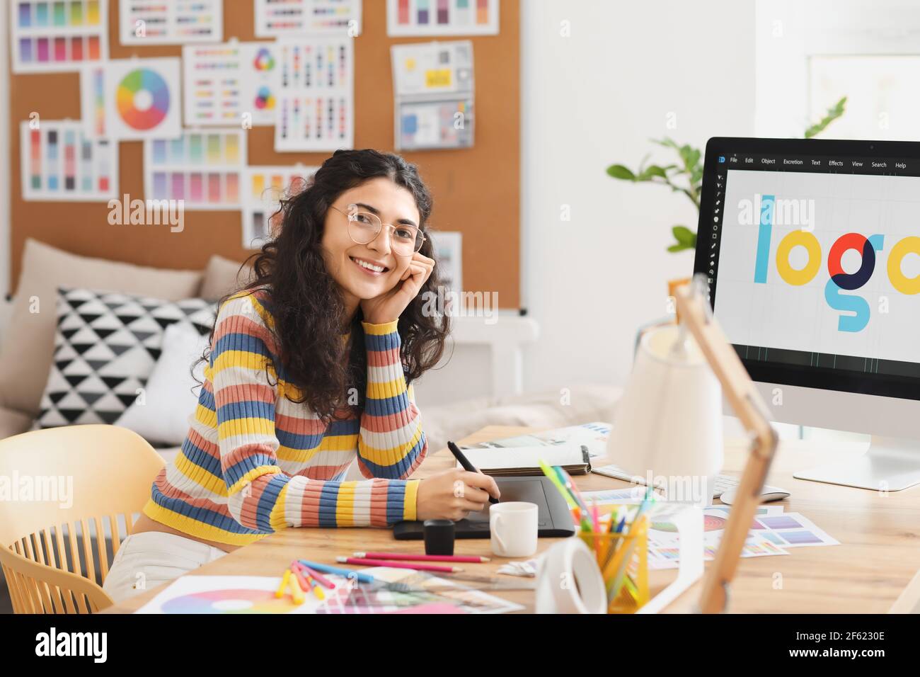 Graphic designer working in office Stock Photo - Alamy
