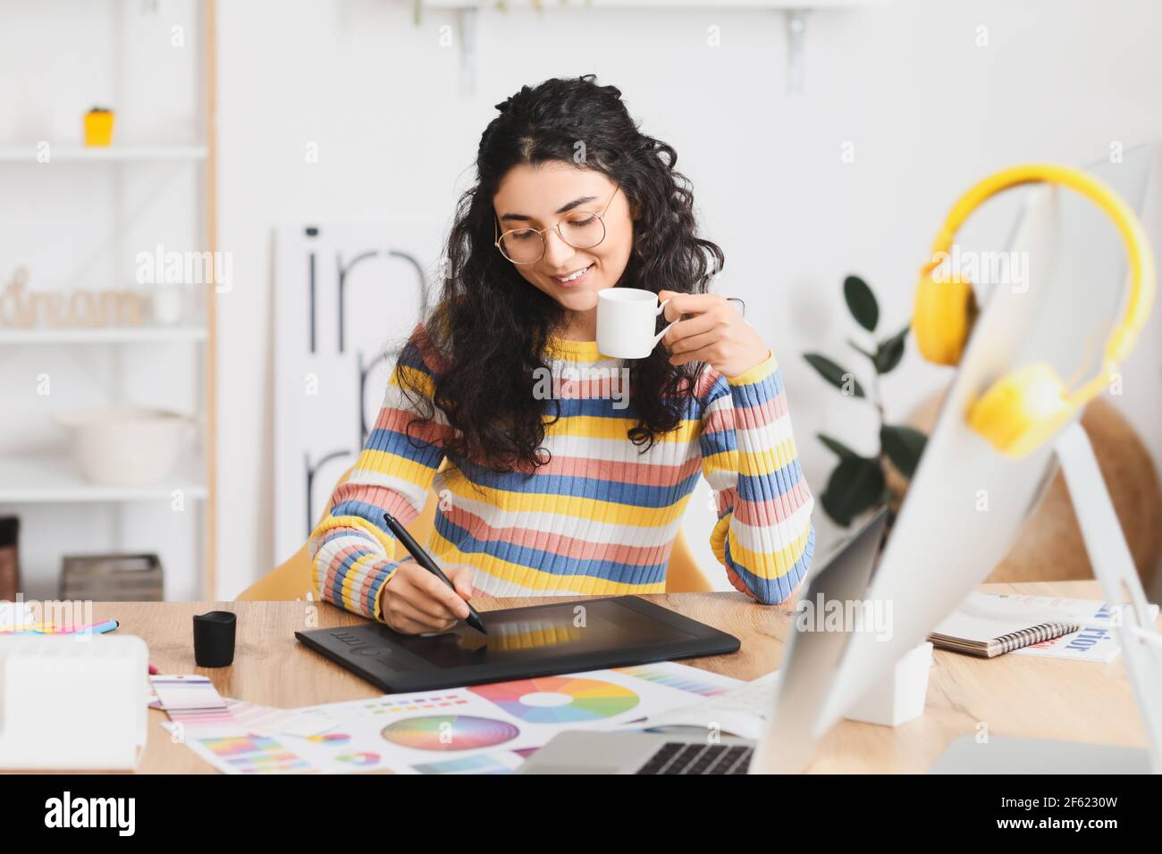 Graphic designer working in office Stock Photo - Alamy