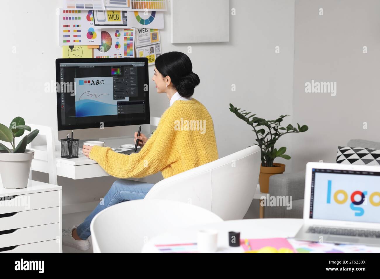 Graphic designer working in office Stock Photo - Alamy