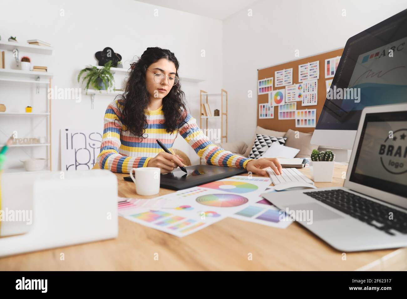Graphic designer working in office Stock Photo - Alamy