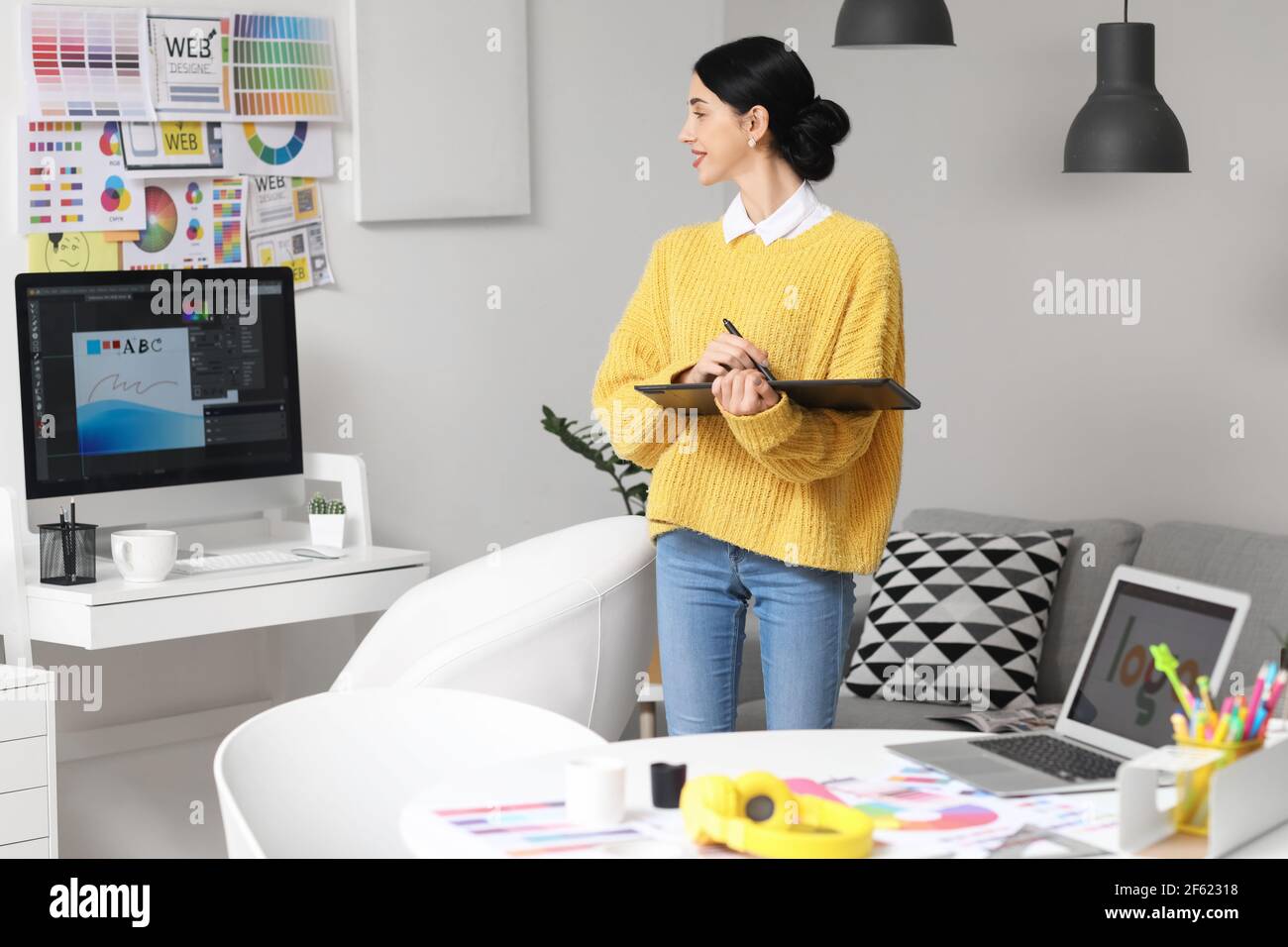 Graphic designer working in office Stock Photo - Alamy