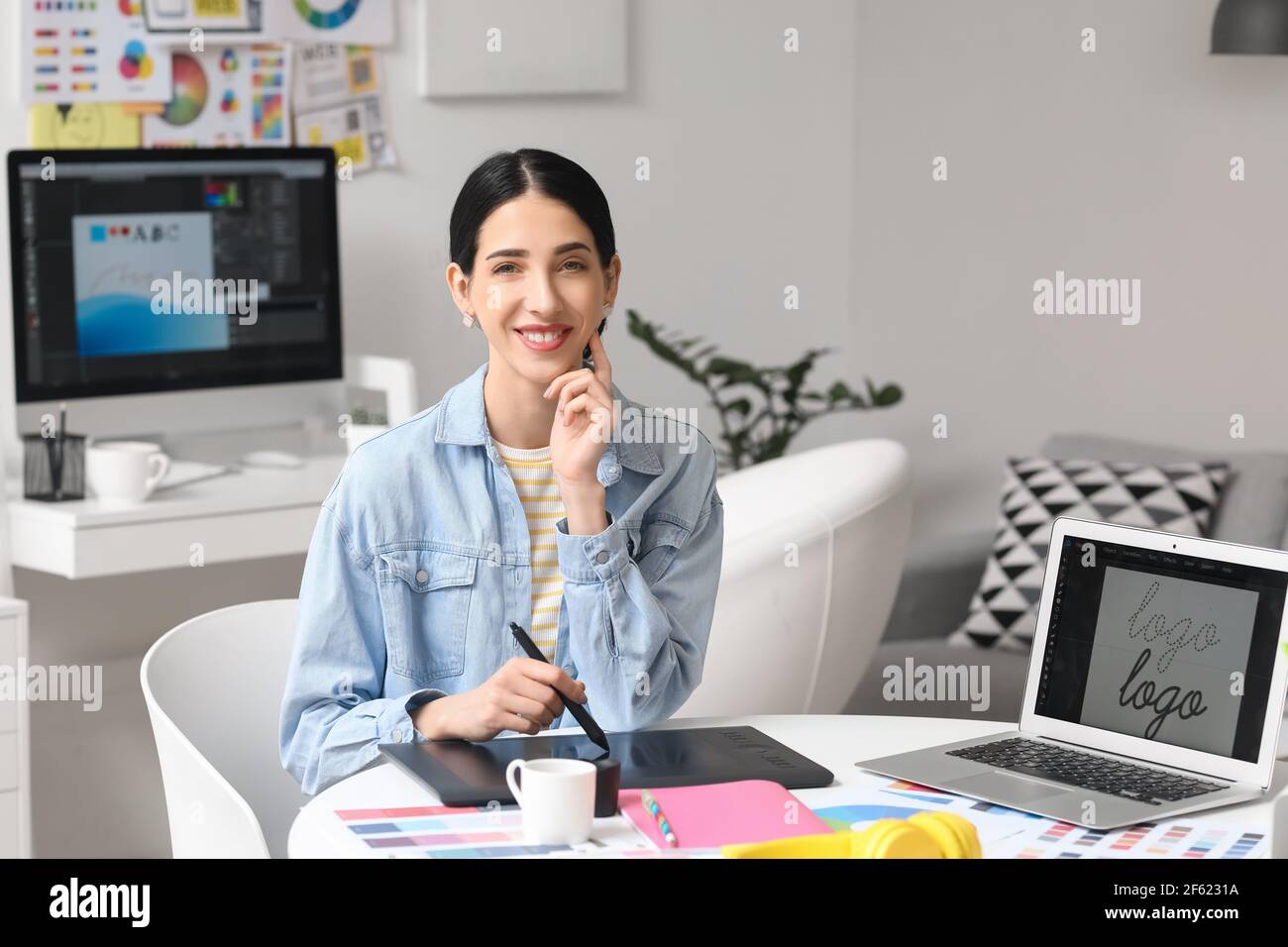 Graphic designer working in office Stock Photo - Alamy