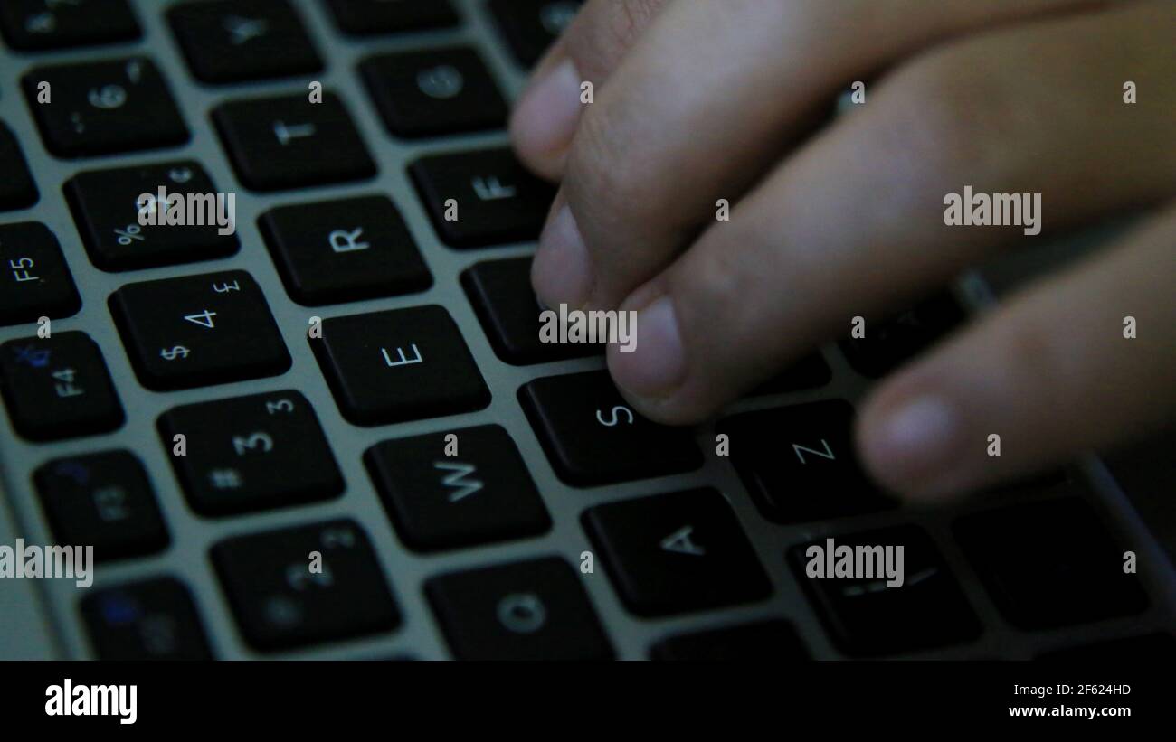 salvador, bahia / brazil: 03/30/2020: person uses computer keyboard to ...