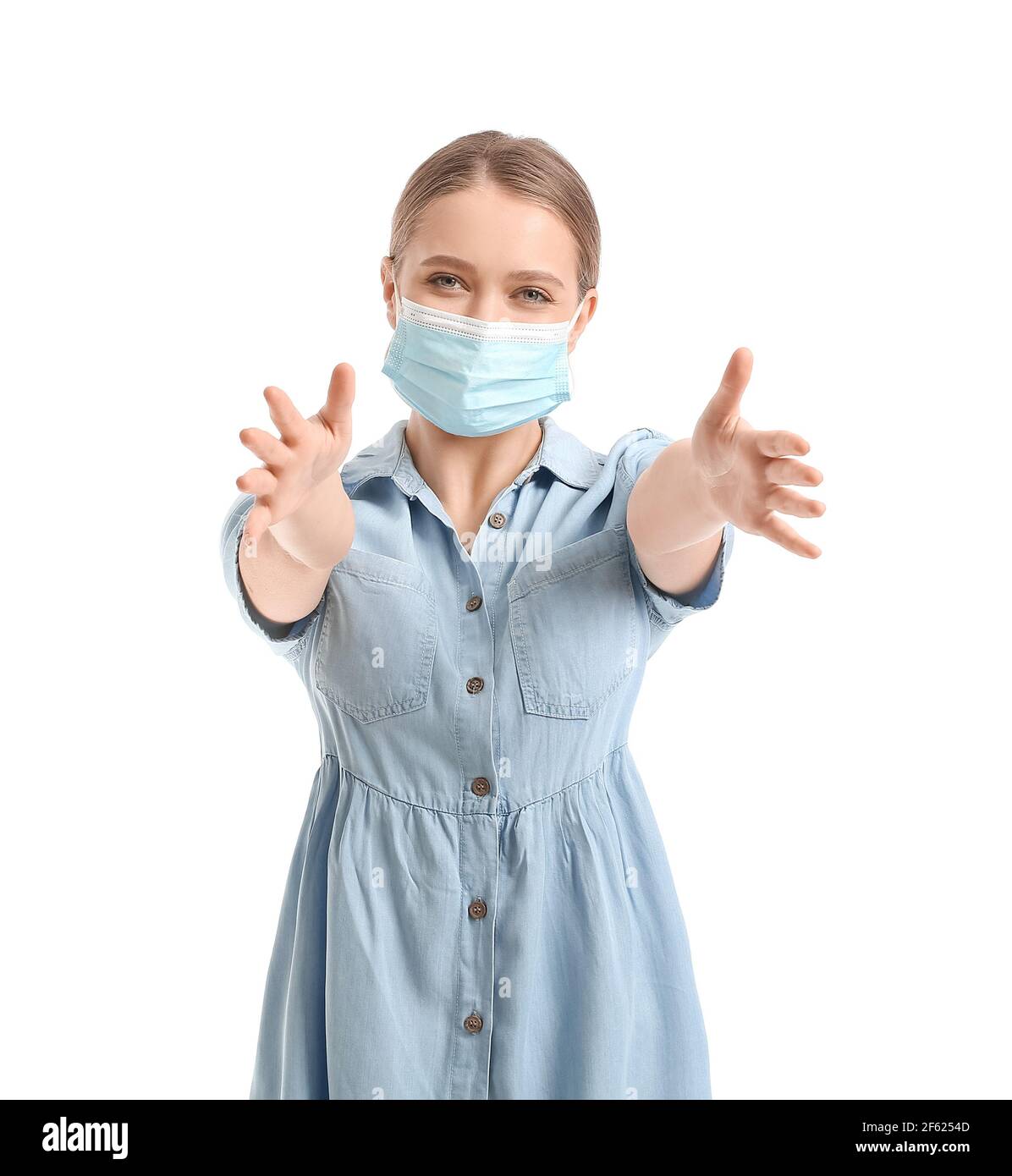 Young woman in medical mask opening arms for hug on white background ...