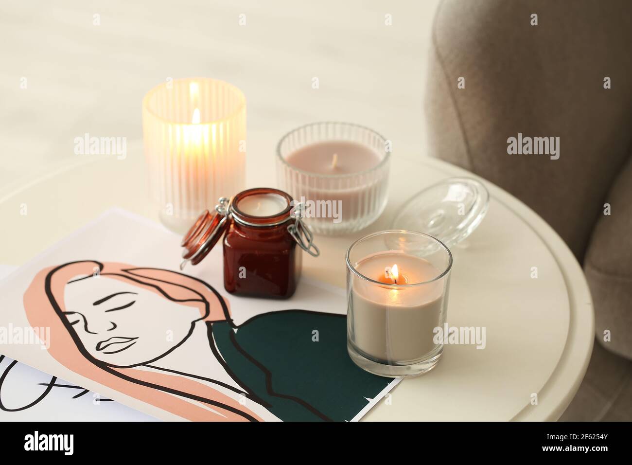 Aroma candles on table in room Stock Photo - Alamy