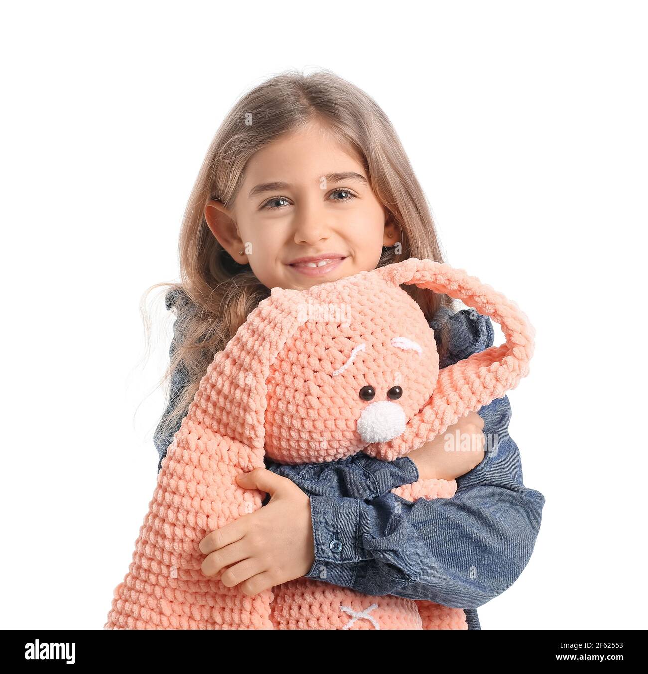 Happy little girl hugging toy on white background Stock Photo - Alamy