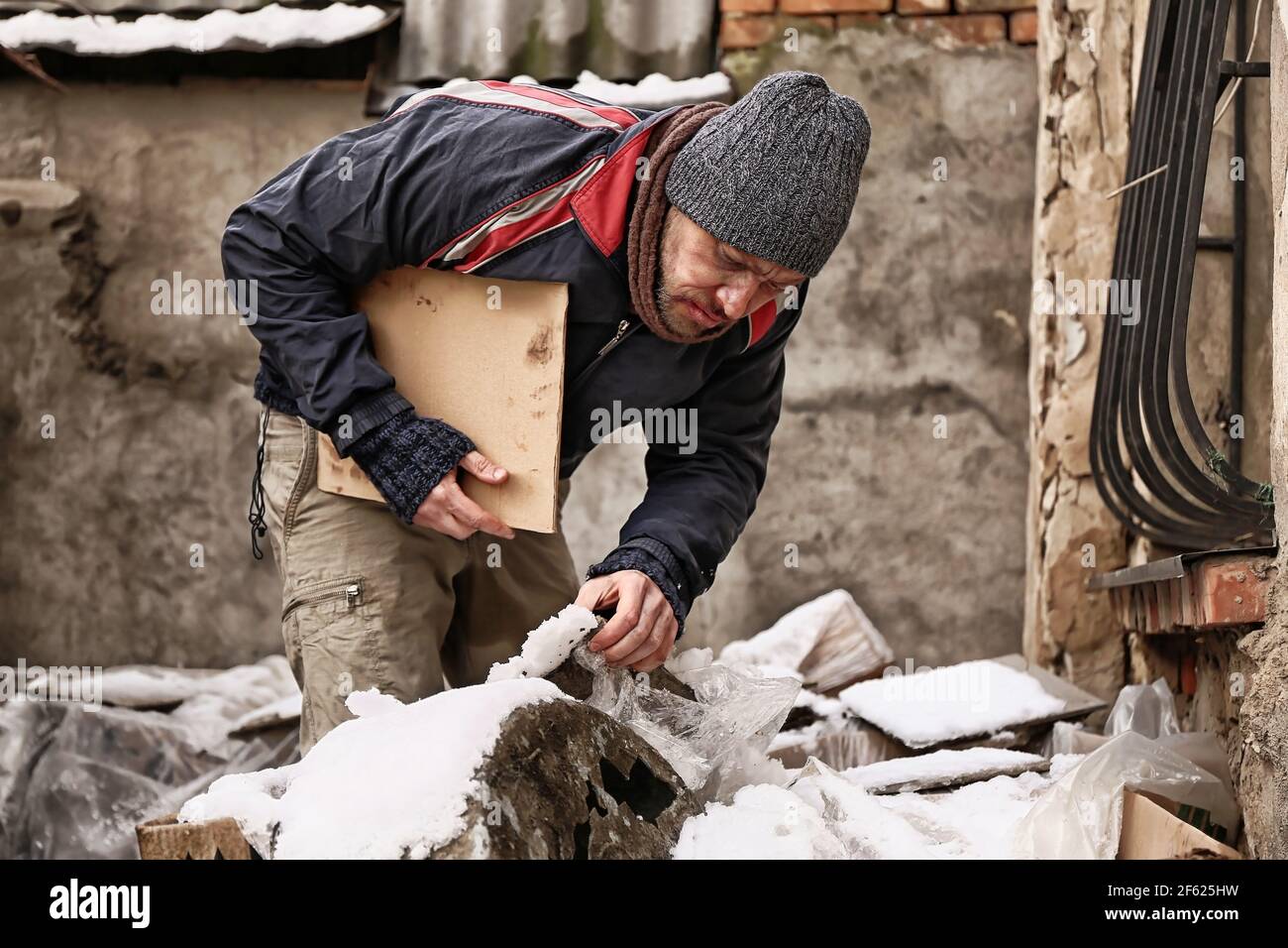 Poor homeless man on junkyard Stock Photo - Alamy