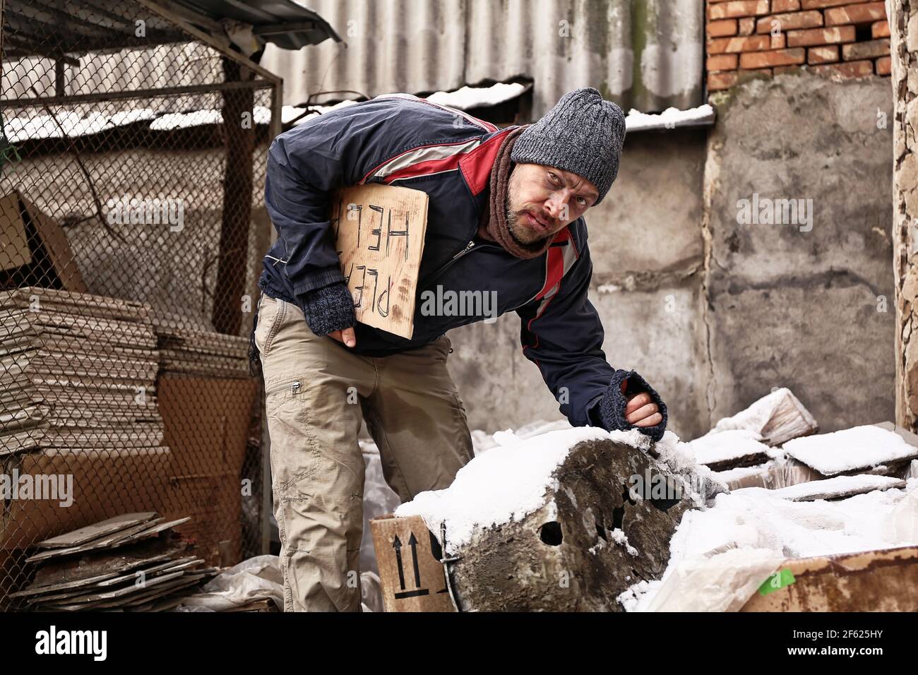 Poor homeless man on junkyard Stock Photo - Alamy
