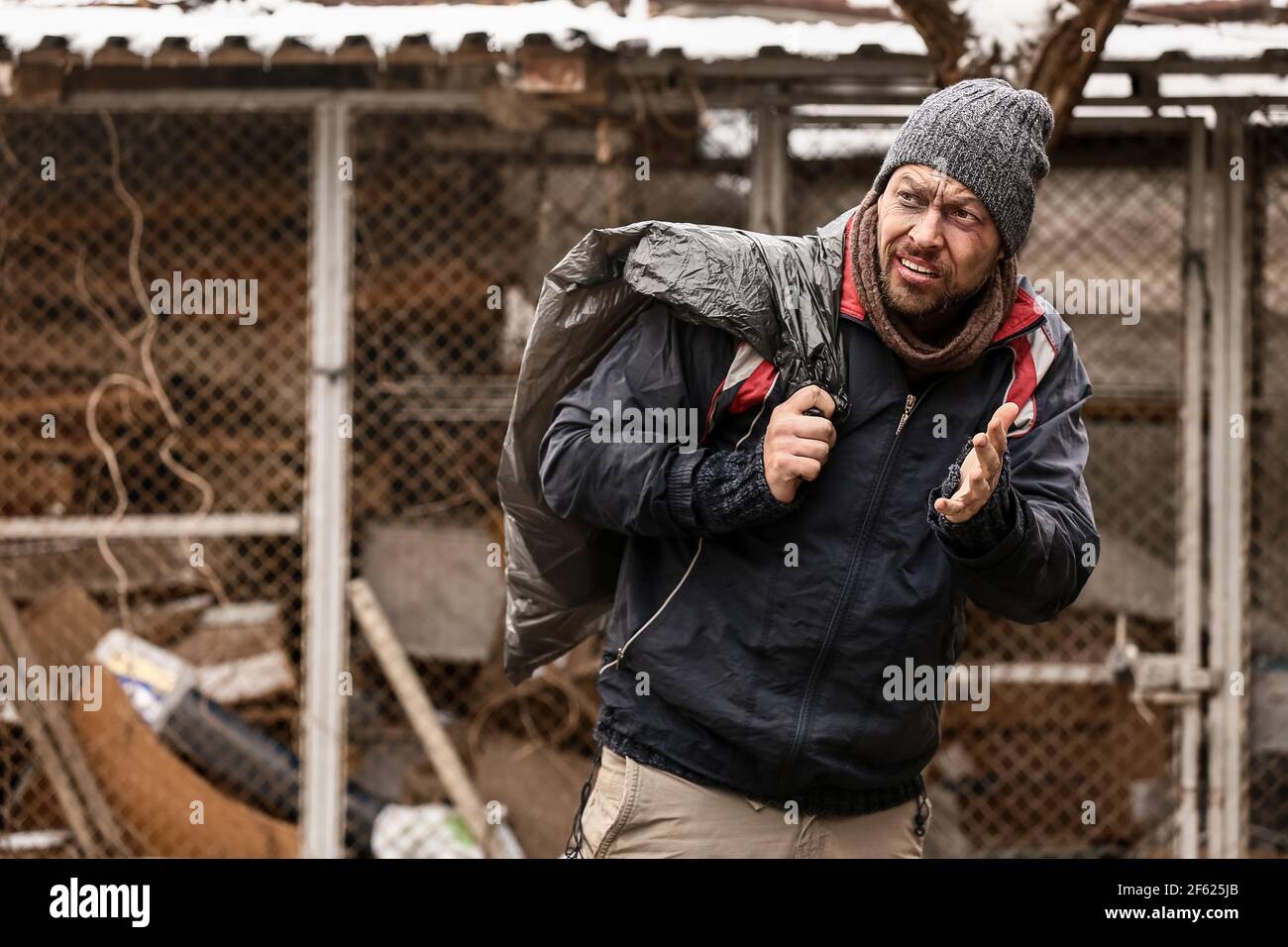 Poor homeless man with trash bag outdoors on winter day Stock Photo - Alamy