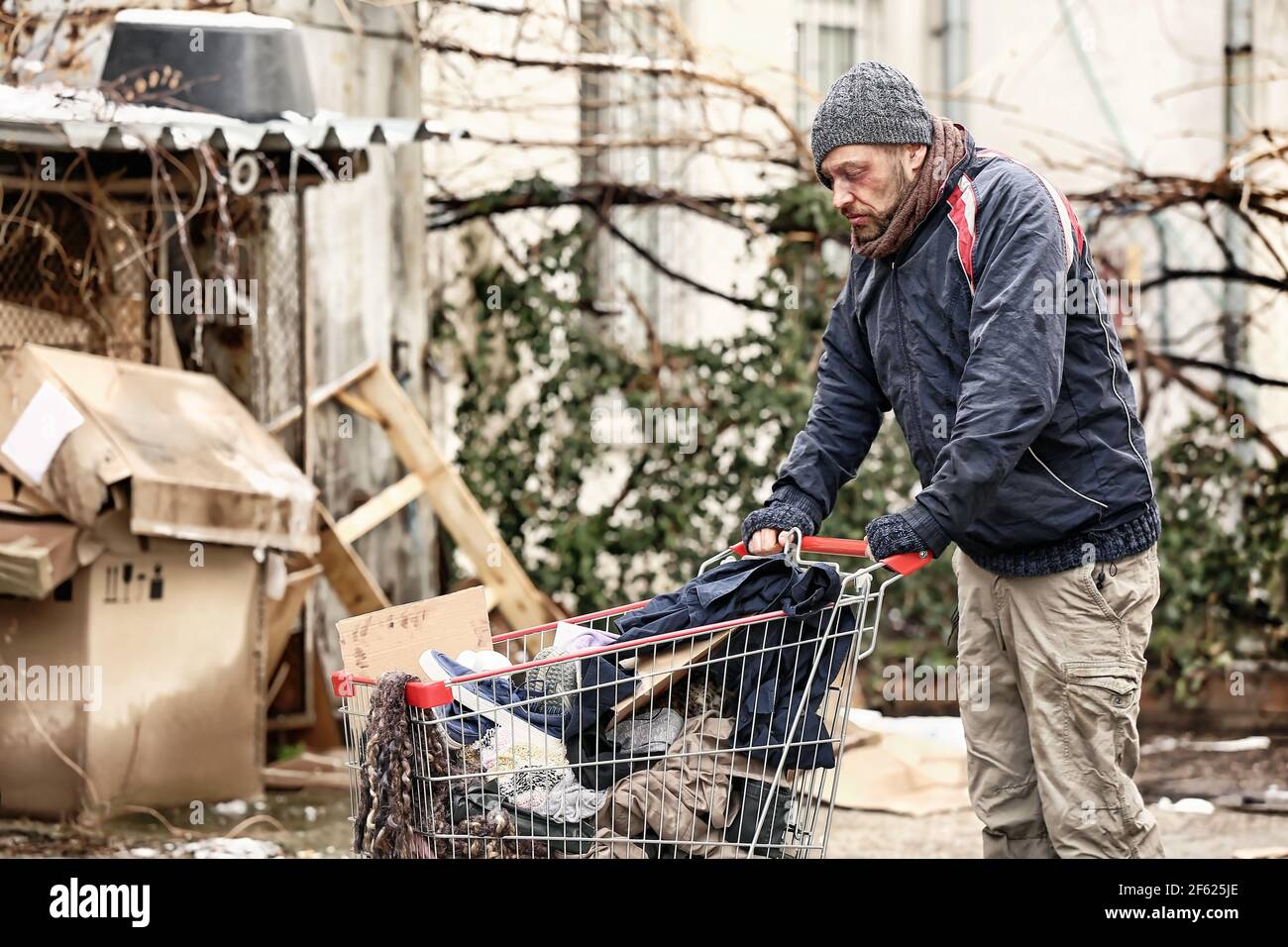 Poor homeless man with donations outdoors on winter day Stock Photo - Alamy