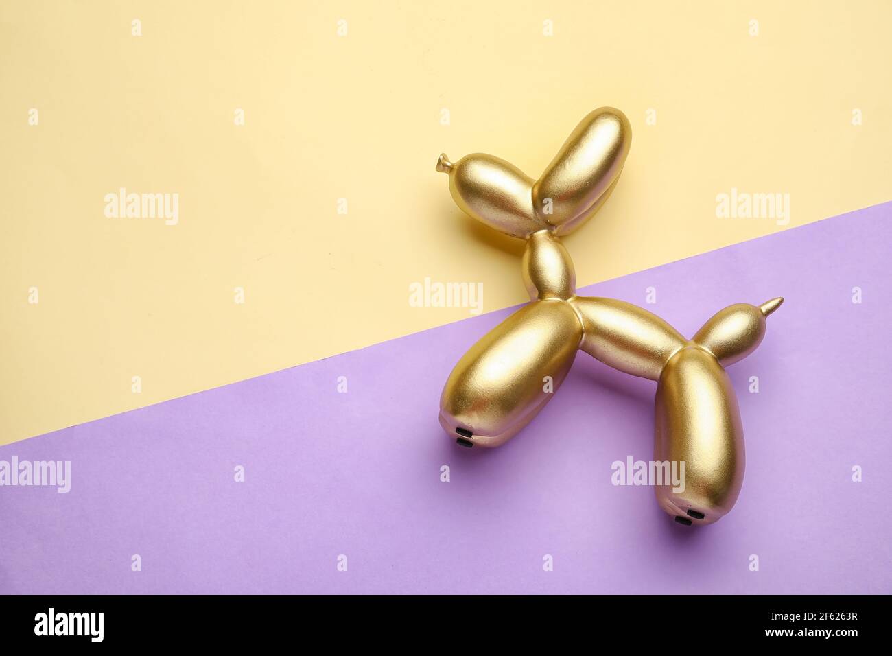 Stylish figurine of balloon dog on color background Stock Photo - Alamy