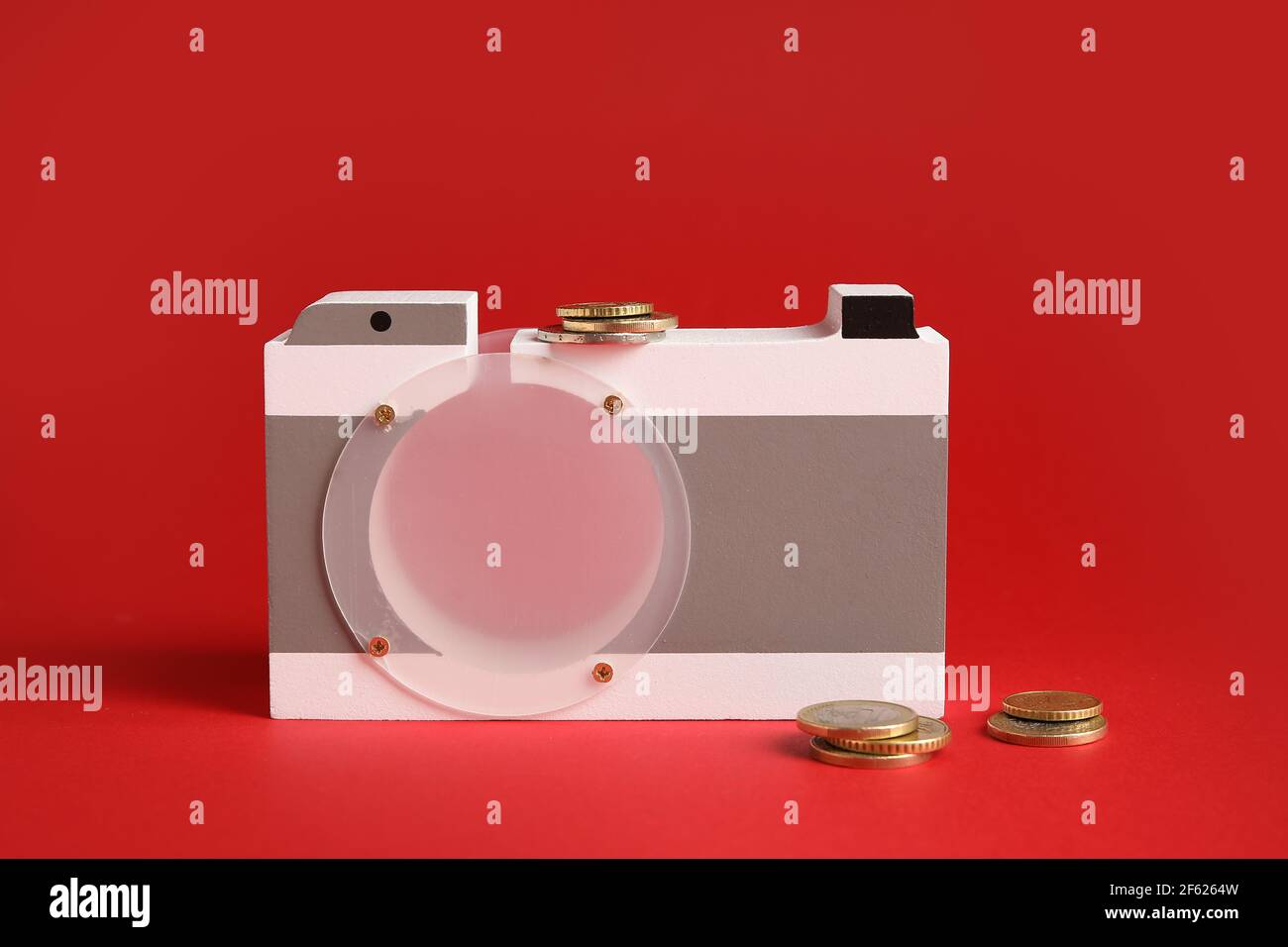 Stylish money box in shape of photo camera on color background Stock ...